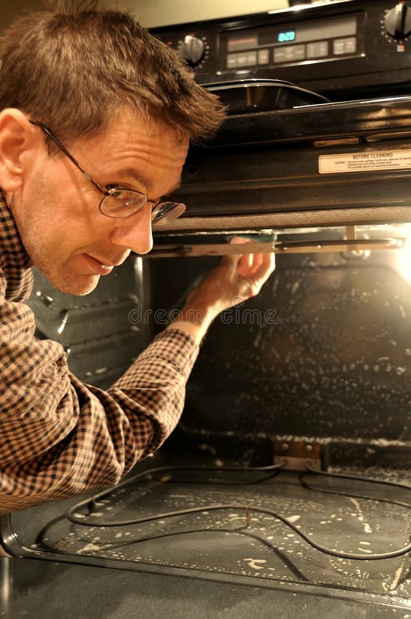 Man Cleaning an Oven stock image. Image of husband, oven - 4336469