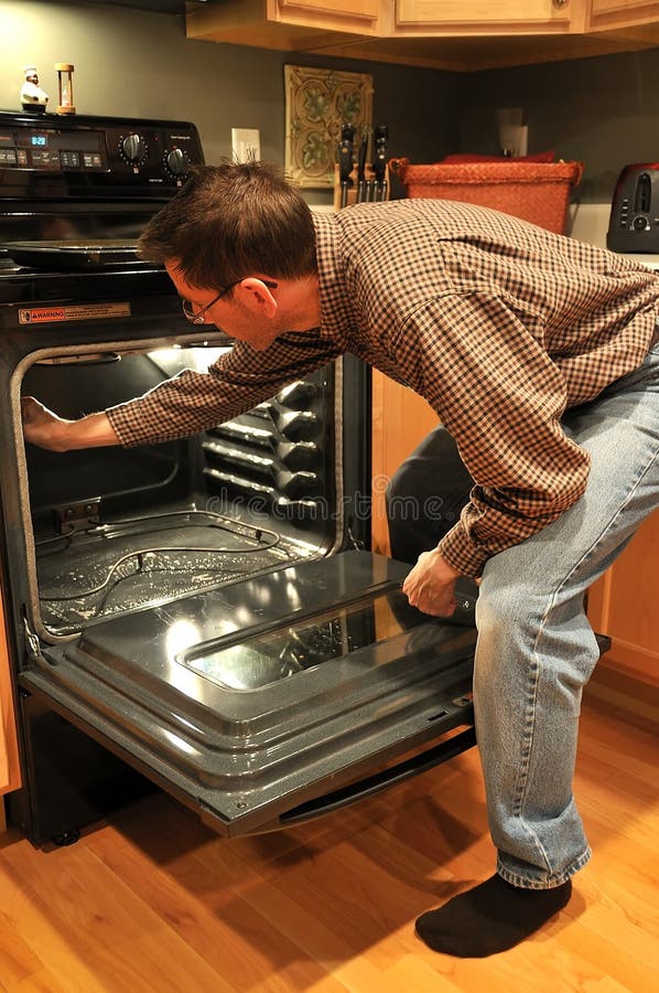 Man Cleaning an Oven stock image. Image of husband, oven - 4336469