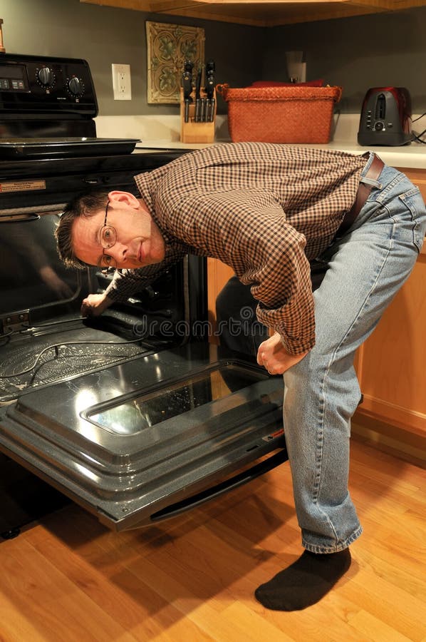 Man Cleaning an Oven stock image. Image of husband, oven - 4336469
