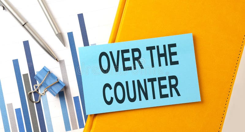 OVER the COUNTER Text on Sticker on the Yellow Notebook with Chart and ...