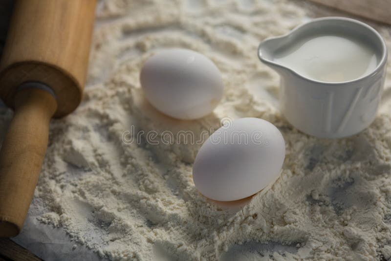 Flour, Eggs and Rolling Pin Placed Over Butter Paper Stock Image ...