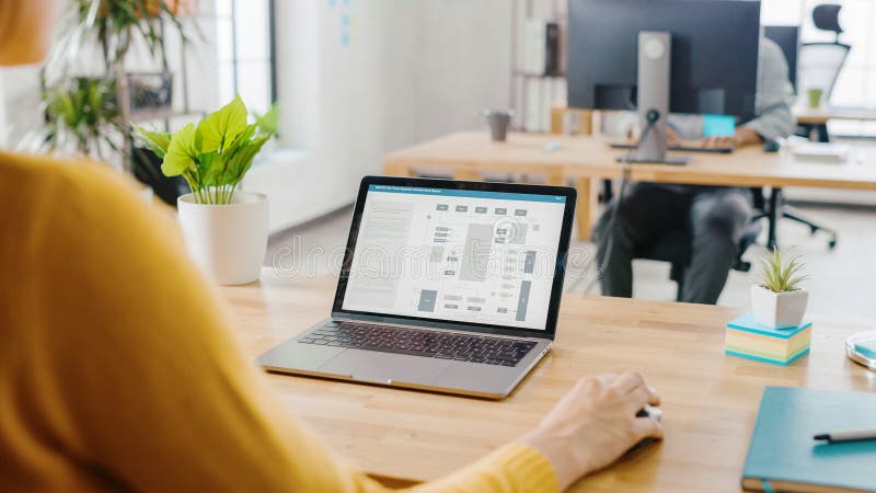 Over the Shoulder: Female Engineer Developer Sitting at Her Desk Using ...
