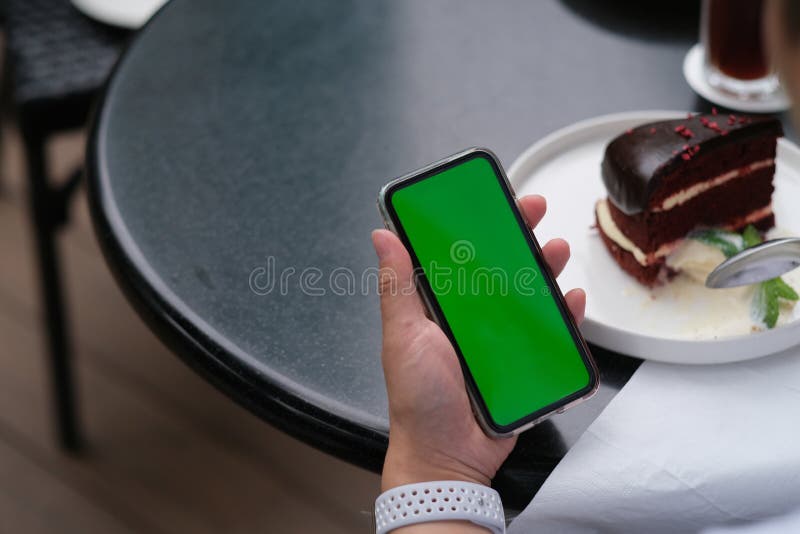Over the Shoulder of Hand Holding Green Screen Smartphone when Eating ...
