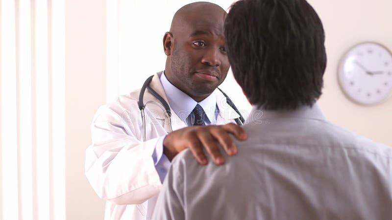 Over the Shoulder Shot of Doctor Talking To Hispanic Patient Stock ...