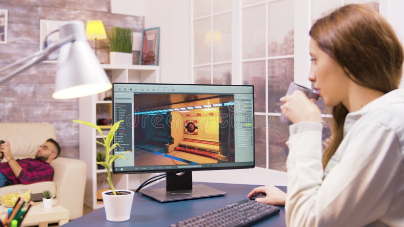 Female Game Developer Works on Level Design on Her Personal Computer ...