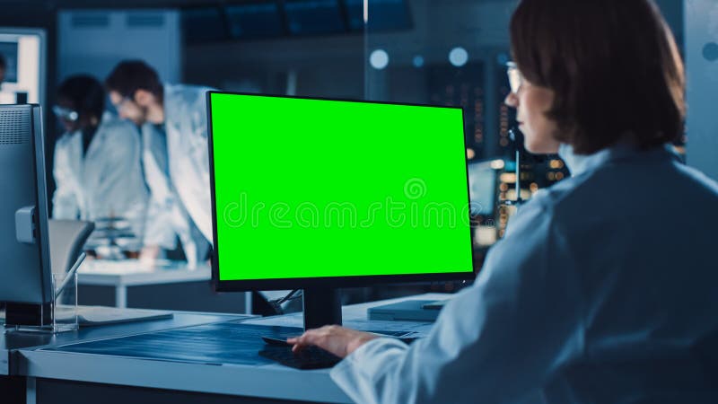 Over the Shoulder Shot: Female it Scientist Uses Green Mock-up Screen ...