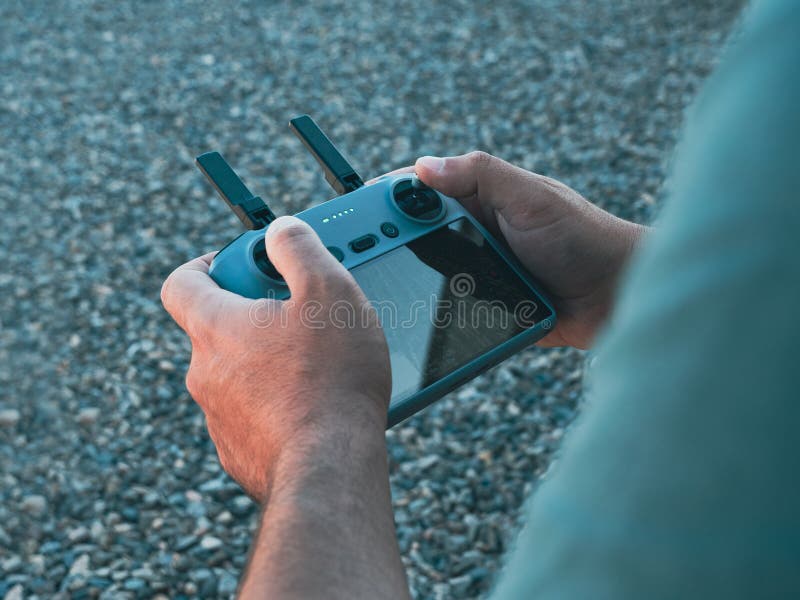 Over the Shoulder Shot of a Man Holding a Drone Remote Control Joystick ...
