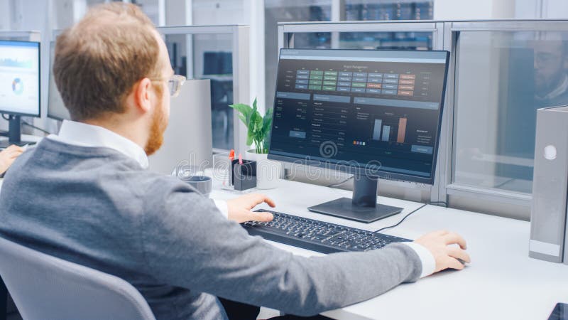 Over the Shoulder Shot of Motivated Businessman Working on Desktop ...
