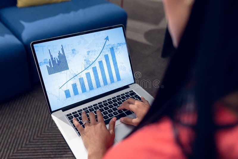 Over Shoulder View of Biracial Woman Using Laptop with Graphs on Blue ...