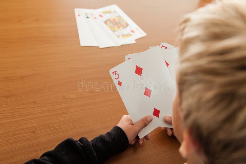 Over the Shoulder View of Child Playing Cards Stock Image - Image of ...
