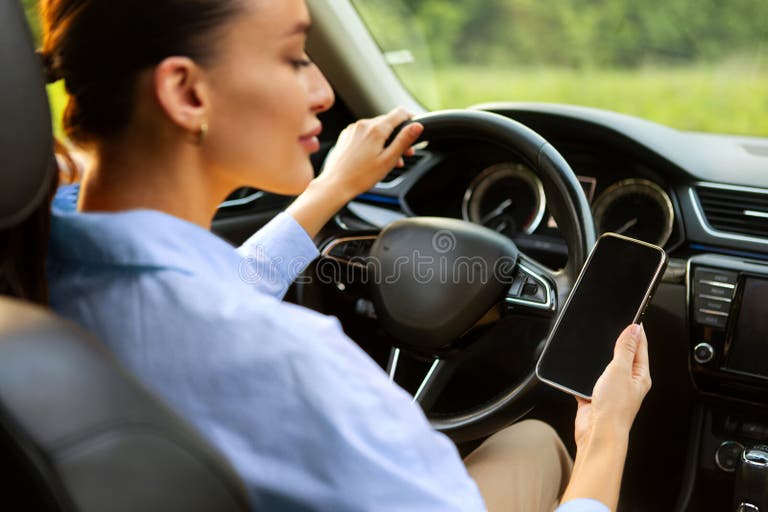 Over the Shoulder View of Lady Driver Holding Cellphone with Blank ...