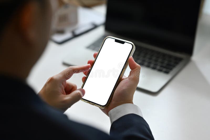 Over Shoulder View of Male Manager Using Smartphone at Desk Stock Photo ...