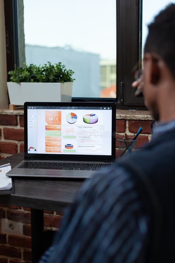 Over Shoulder View of Startup Employee Analyzing Business Key ...