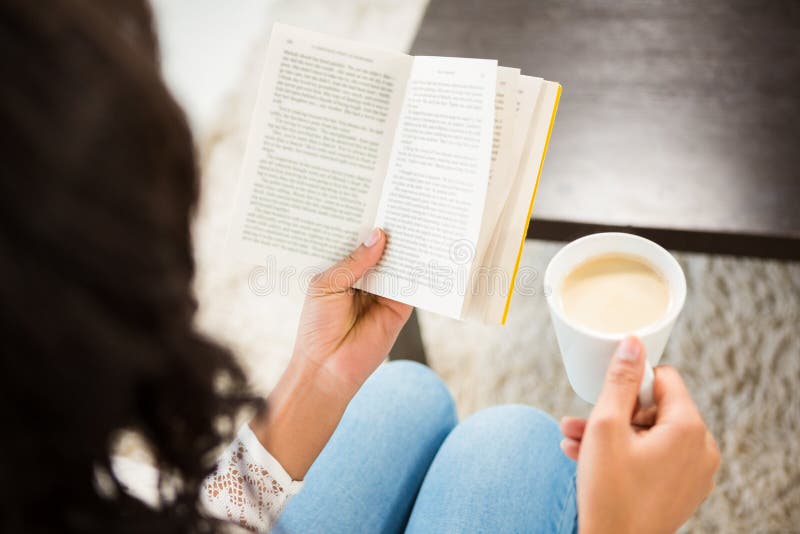 Over Shoulder View of Woman Holding Cup of Coffee and Book Stock Photo ...