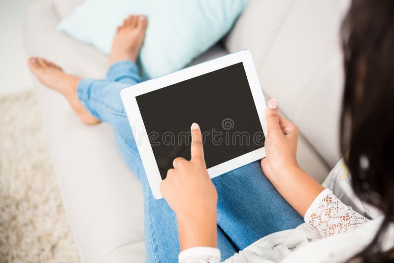Over Shoulder View of a Woman Using Tablet on the Couch Stock Photo ...