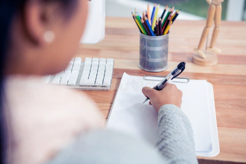 Over Shoulder View of Woman Writing on White Sheet Stock Photo - Image ...