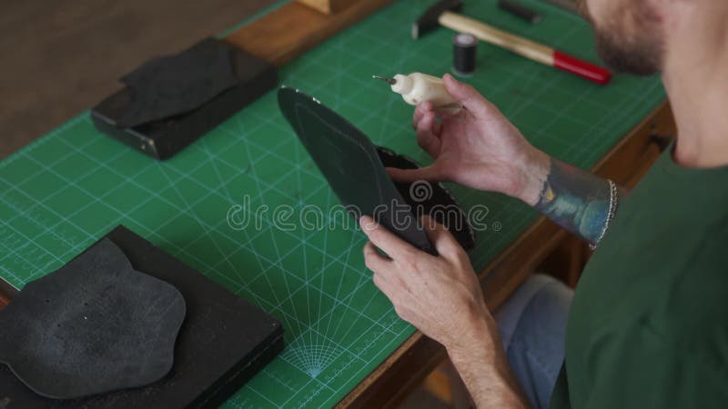 Over Shoulder View of Young Professional Leather Craftsman Sits at Work ...