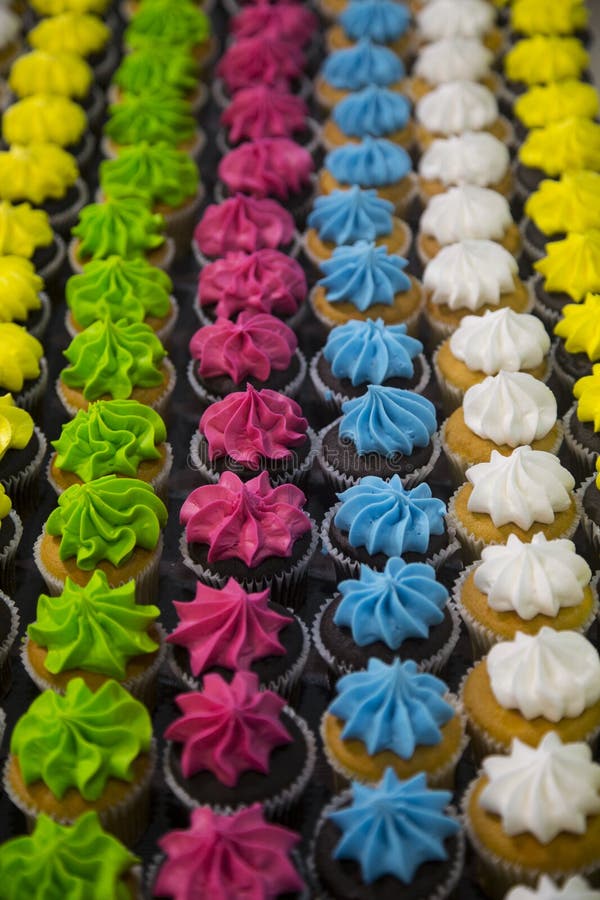 Over Three Dozen Brightly Colored Cupcakes in Vertical Rows Stock Image ...