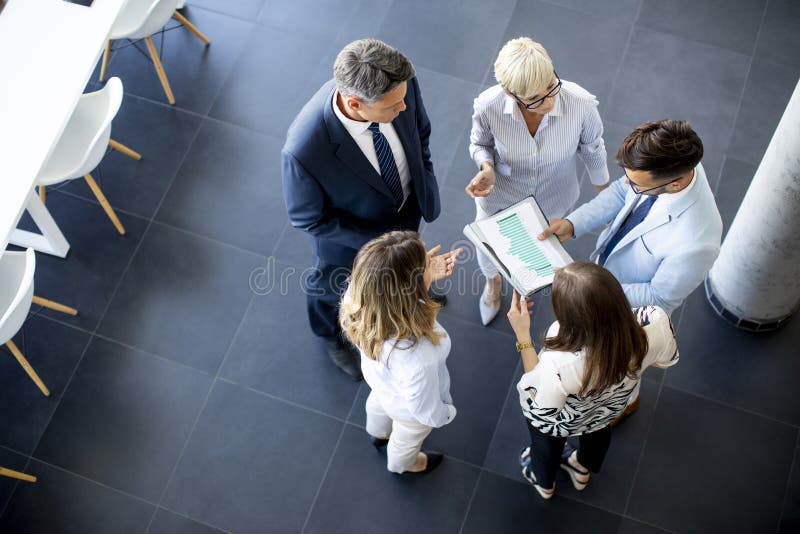 Group of Businesspeople Standing in the Office and Analyzing Plan Stock ...