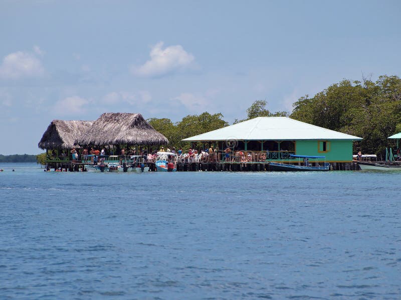 Tropical Restaurant With Thatched Roof Over Water Stock Photo - Image ...
