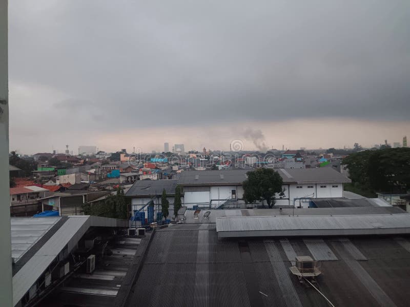 Overcast Cityscape: Industrial Rooftops and Urban Sprawl Under a Cloudy ...