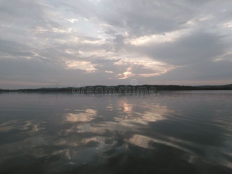 Overcast River reflections stock photo. Image of waves - 160050026