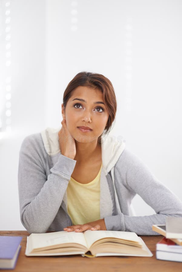 Overcoming a Problem. a Beautiful College Student Sitting at Her Desk ...