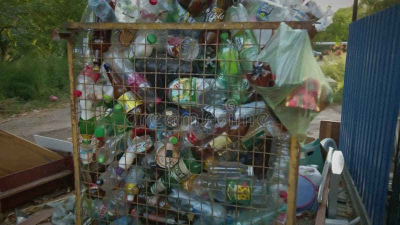 An Overfilled Iron Grid Trash Dumpster is a Visual Representation of ...