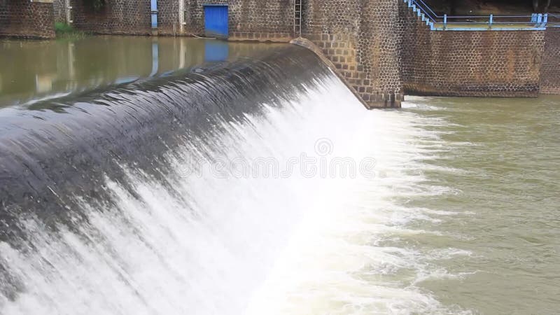 Overflowing Dam with Smooth Cascading Water, a Rustic Stone Foundation ...