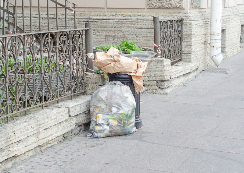 Overflowing Garbage Litter Bin and Full Plastic Package with Garbage in ...
