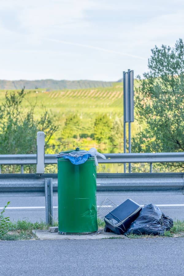 An Overflowing Rubbish Bin at the Roadside Shows Problems with Disposal ...