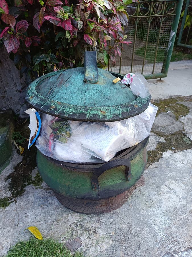 Overflowing Trash Can in a Garden Setting Outdoors Stock Image - Image ...
