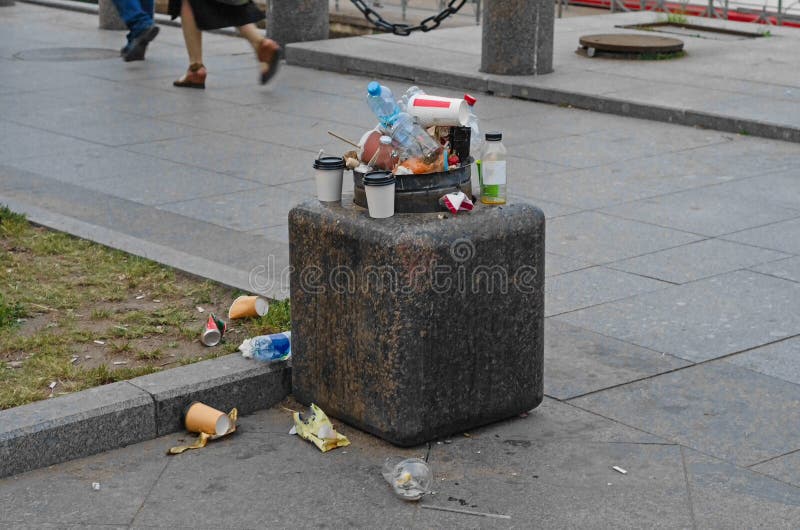 Overflowing Trash Can and Scattered Garbage Nearby in the Park.the ... Overflowing Trash Can and Scattered Garbage Nearby in the Park.the ...