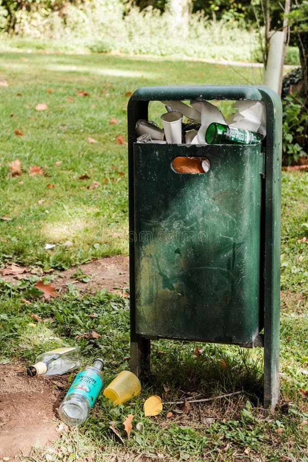 Overflowing Trashcan in a Park with More Trash Laying in Front of it ...