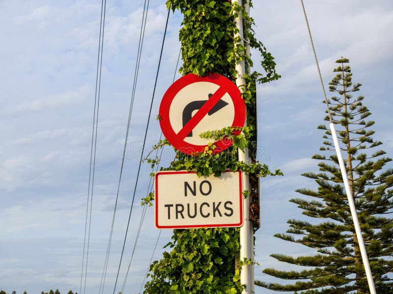 Overgrown Road Sign and No Trucks Warning Stock Image - Image of urban ...