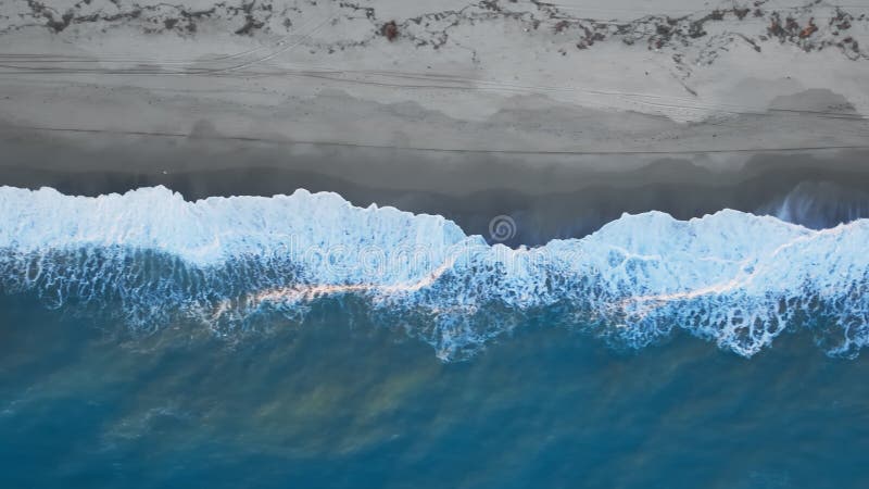 Overhead of a Beach after a Sunset with Sandy Beach and Ocean with Long ...