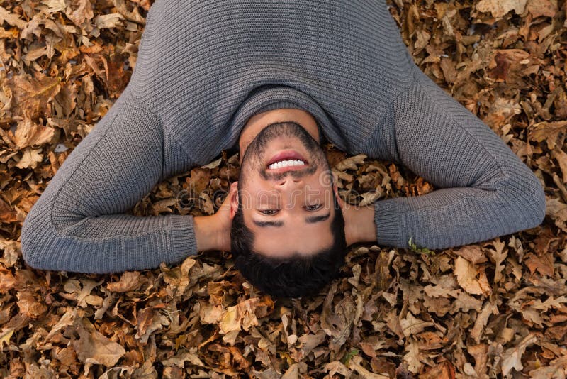 Overhead of Man Lying on Autumn Leaves Stock Photo - Image of leaf ...