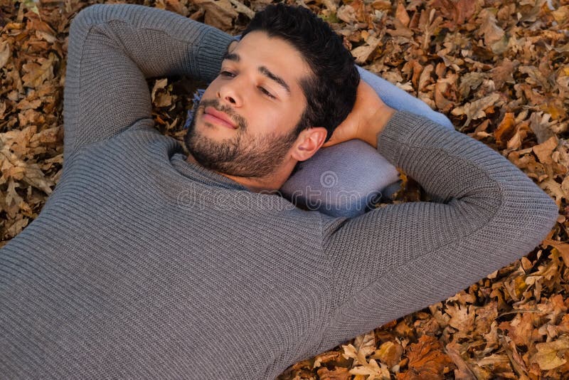 Overhead of Man Lying on Autumn Leaves Stock Photo - Image of brown ...