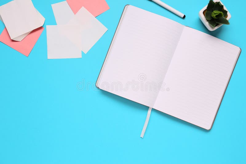 Overhead of Office Table with Notepad, Notebook and Clock and Felt Pen ...