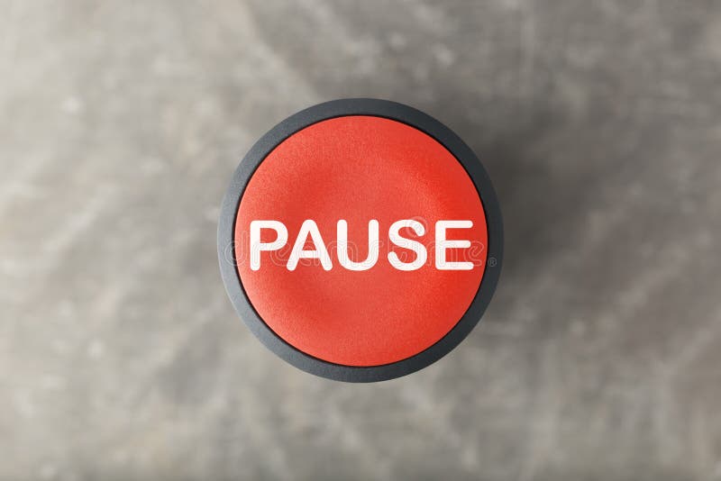 Overhead of Red Pause Button Over Blurred Gray Background Stock Photo ...