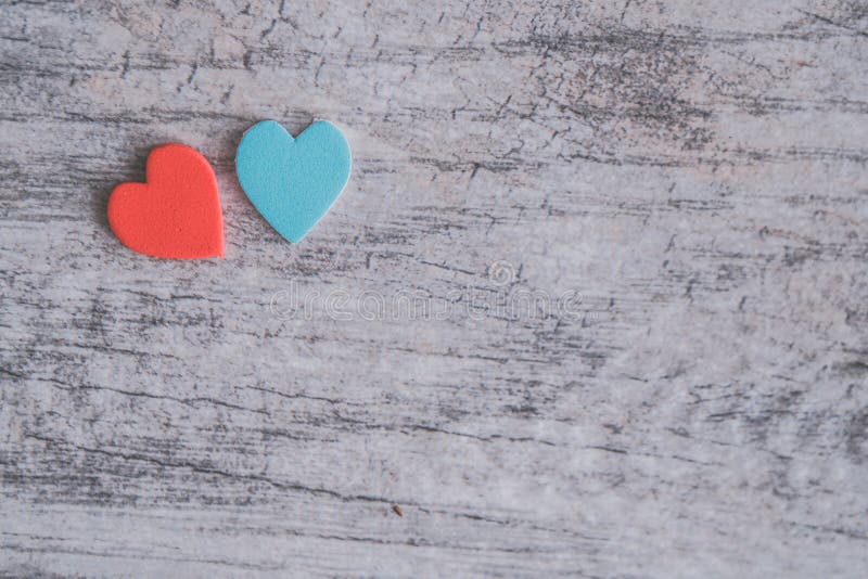 Overhead Shot of a Blue and a Red Heart on a Wooden Surface with Space ...