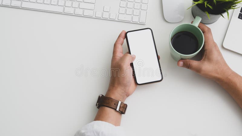 Overhead Shot of Businessman Using Smartphone in Modern Workspace with ...