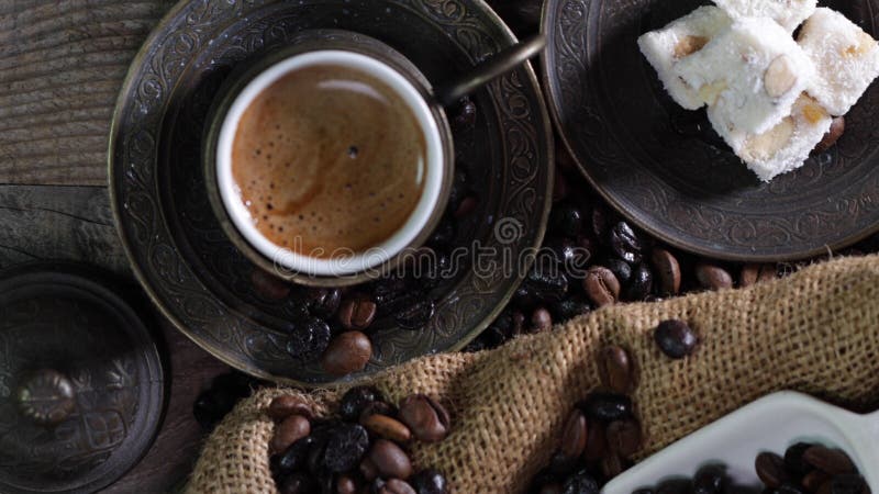 Overhead Shot of a Cup Full of Coffee with Coffee Beans Next To it ...