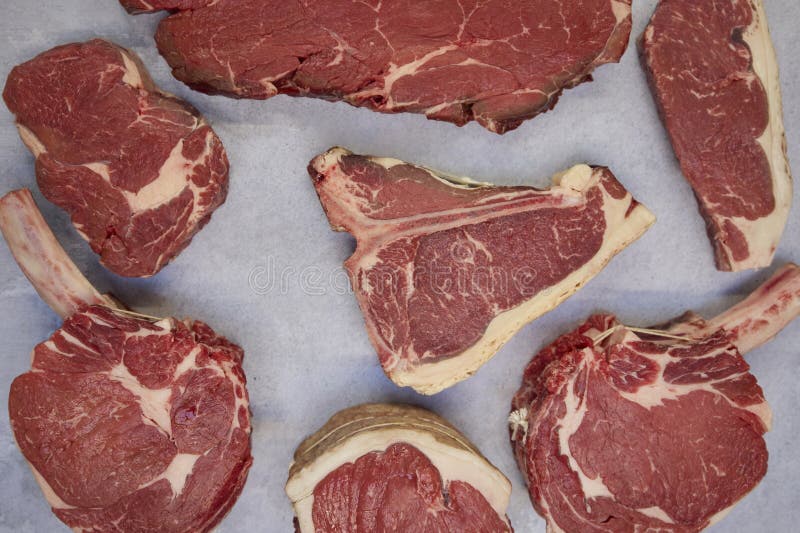 Overhead Shot of Different Cuts of Beef Steak on Background in Butcher ...