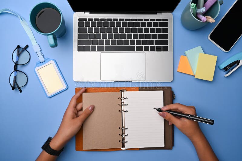 Female Office Worker Writing Information on Notebook. Stock Photo ...