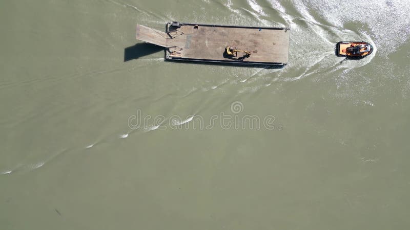 Overhead Shot of a Motor Boat Pulling a Barge Up the Frasier River in ...