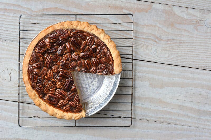 Overhead Shot of a Pecan Pie with a Slice Cut Out on a Cooling Rack ...