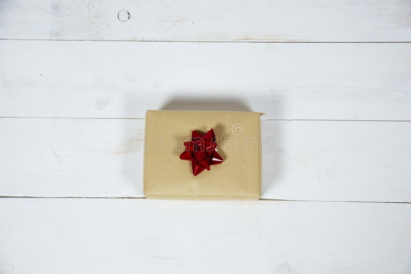 Overhead Shot of a Present with a Red Bow on a White Wooden Surface ...