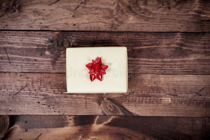Overhead Shot of a Present with a Red Bow on a Wooden Surface Stock ...