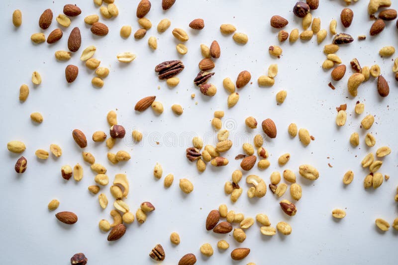 Overhead Shot of Scattered Different Types of Nuts on a White Surface ...